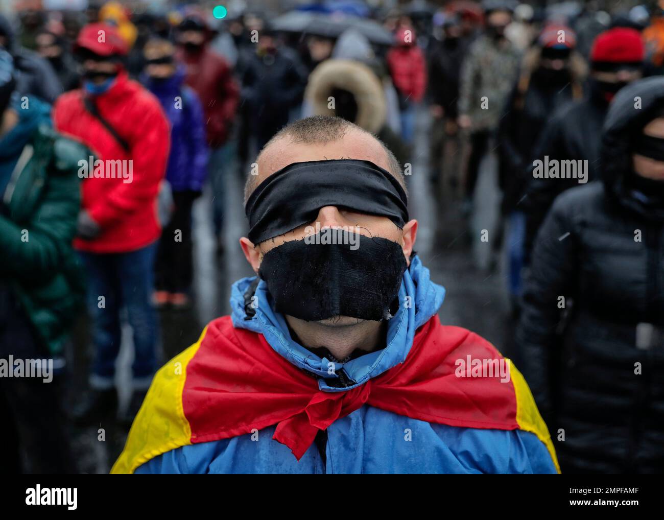 A man stands as he takes part in a flash mob in Bucharest, Romania ...