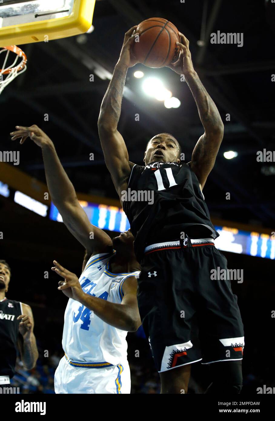 Cincinnati forward Gary Clark (11) pulls down a rebound against UCLA ...