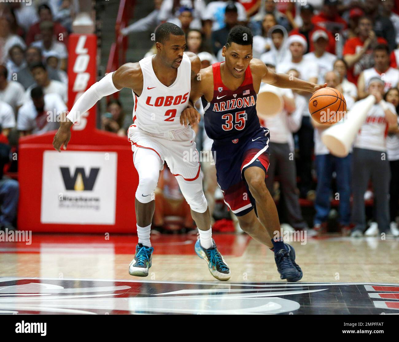 Arizona's Allonzo Trier tries to dribble past New Mexico's Sam Logwood ...