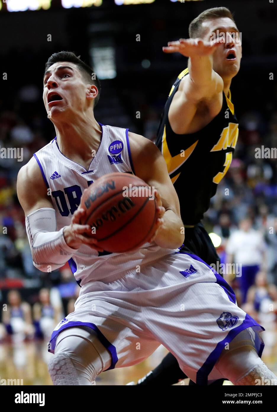 Drake guard Reed Timmer drives to the basket past Iowa guard Jordan ...