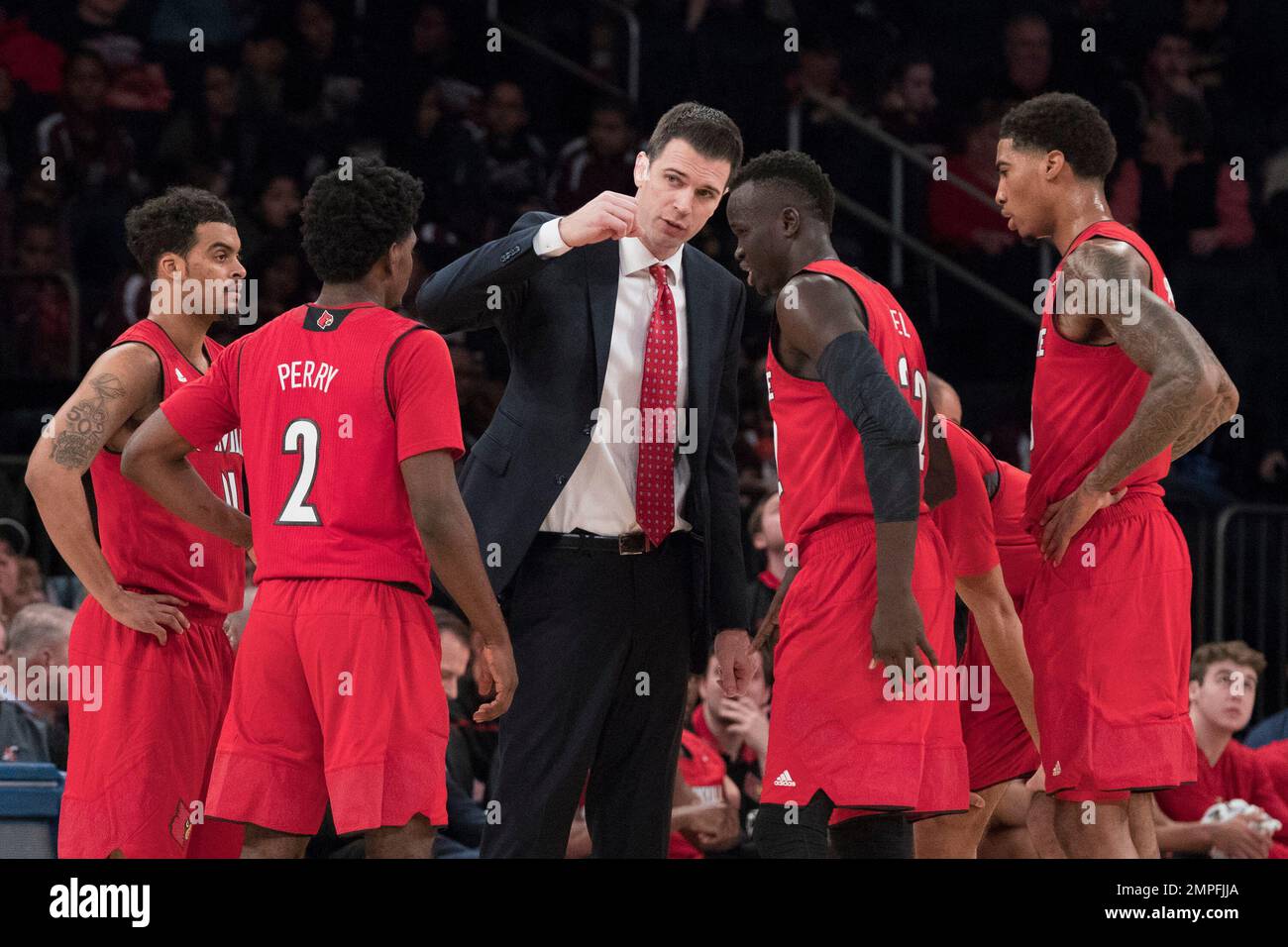 Louisville head coach David Padgett, center, talks to his team during a ...