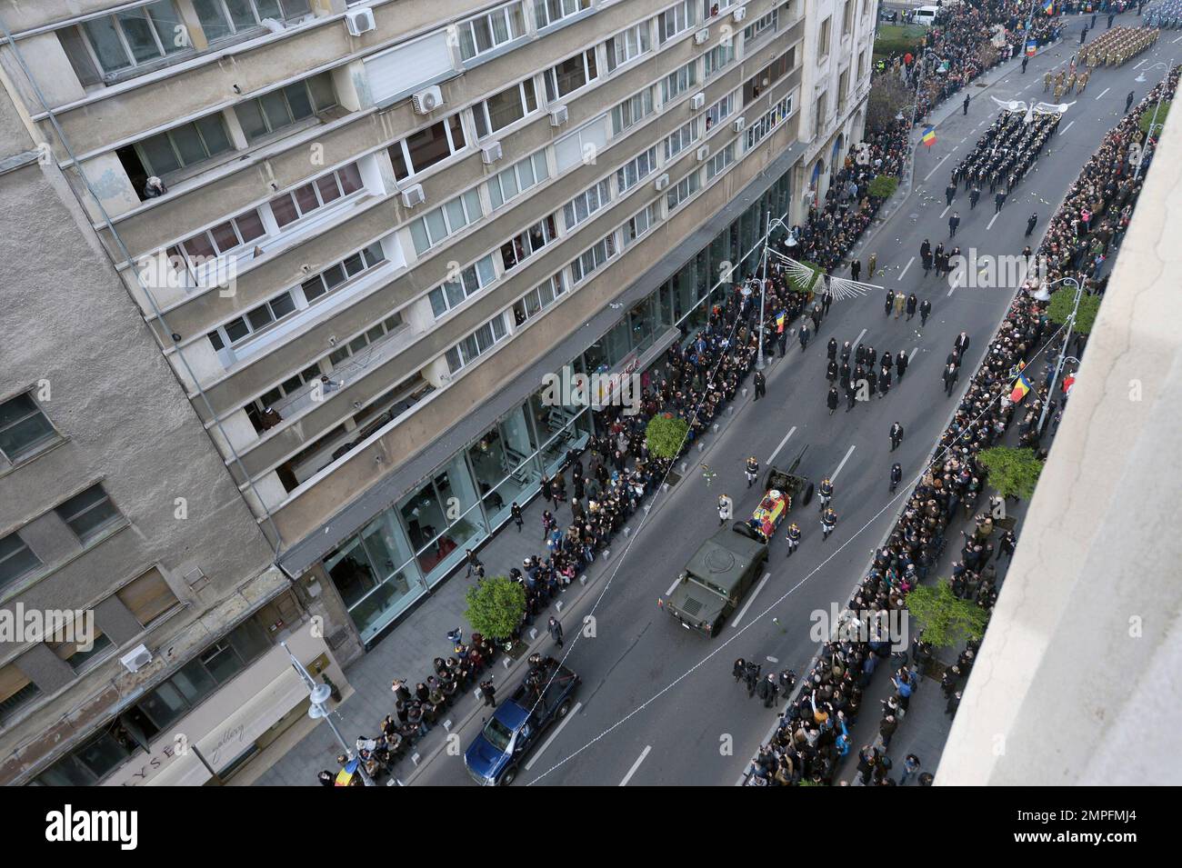 People watch the motorcade with the coffin of the late Romanian King ...