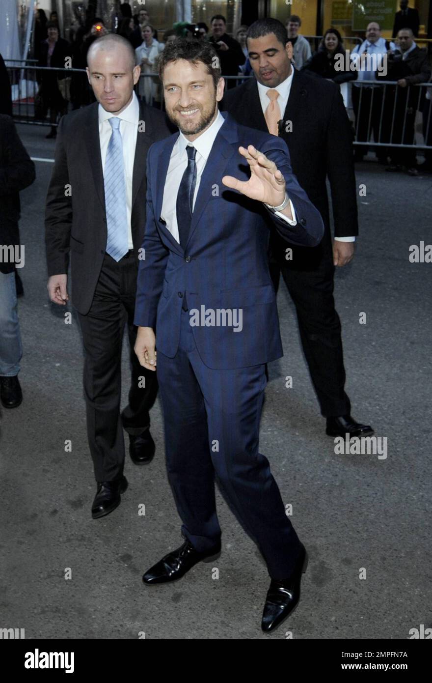 Gerard Butler is all smiles as he greets fans and signs autographs ...