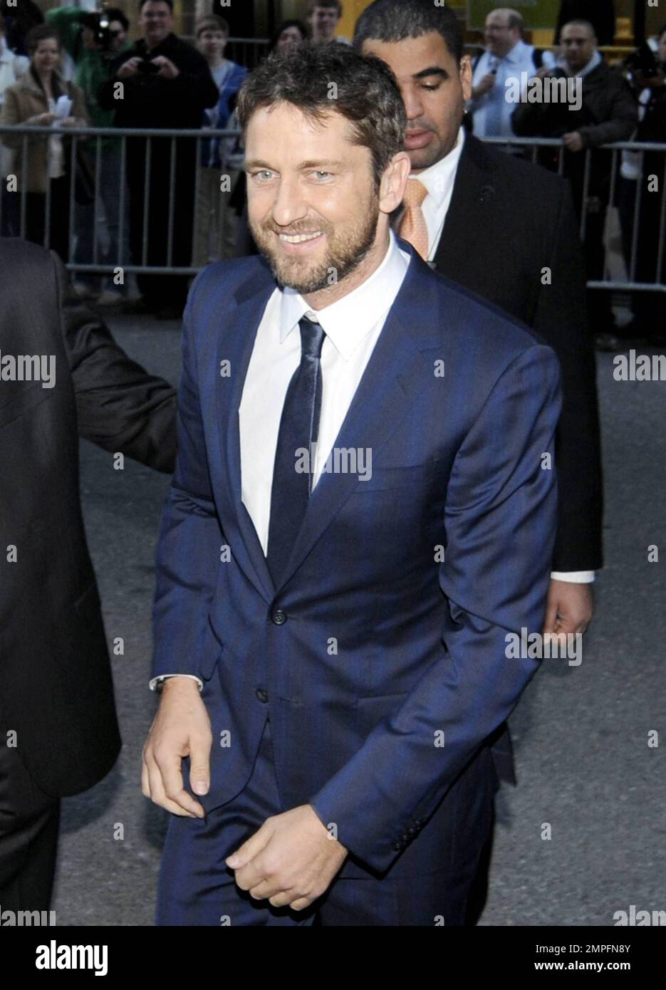 Gerard Butler is all smiles as he greets fans and signs autographs ...