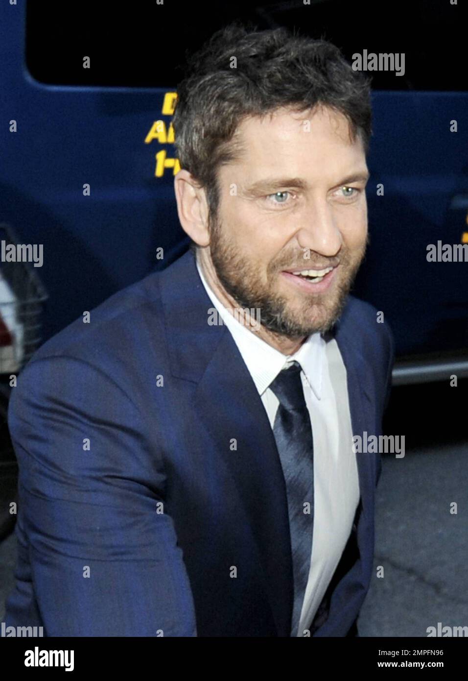 Gerard Butler is all smiles as he greets fans and signs autographs ...