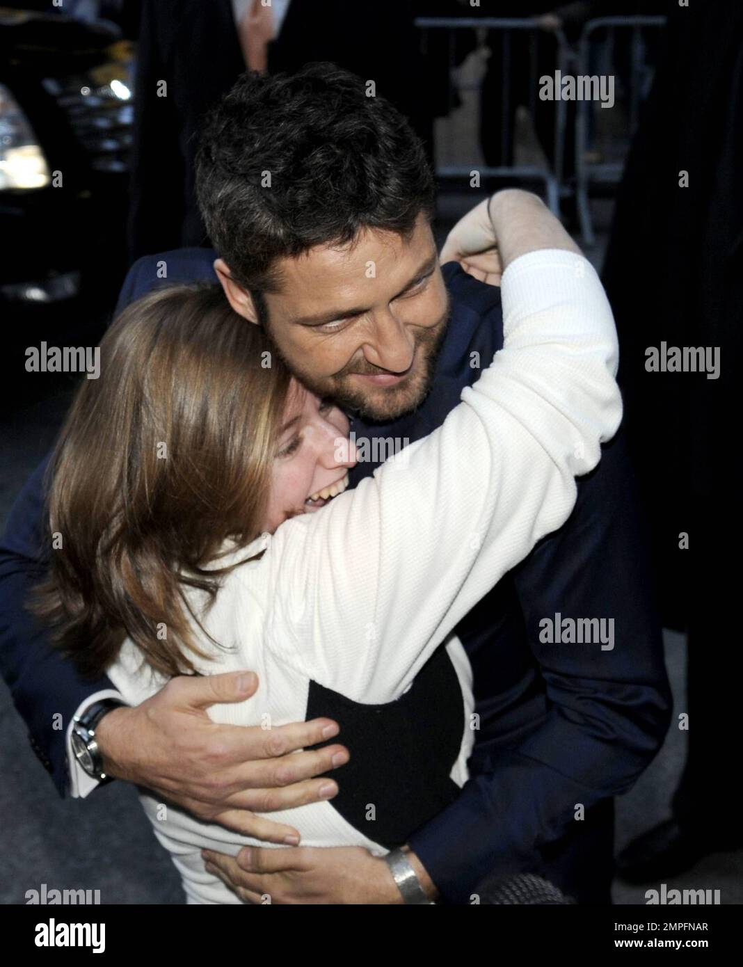 Gerard Butler is all smiles as he greets fans and signs autographs ...