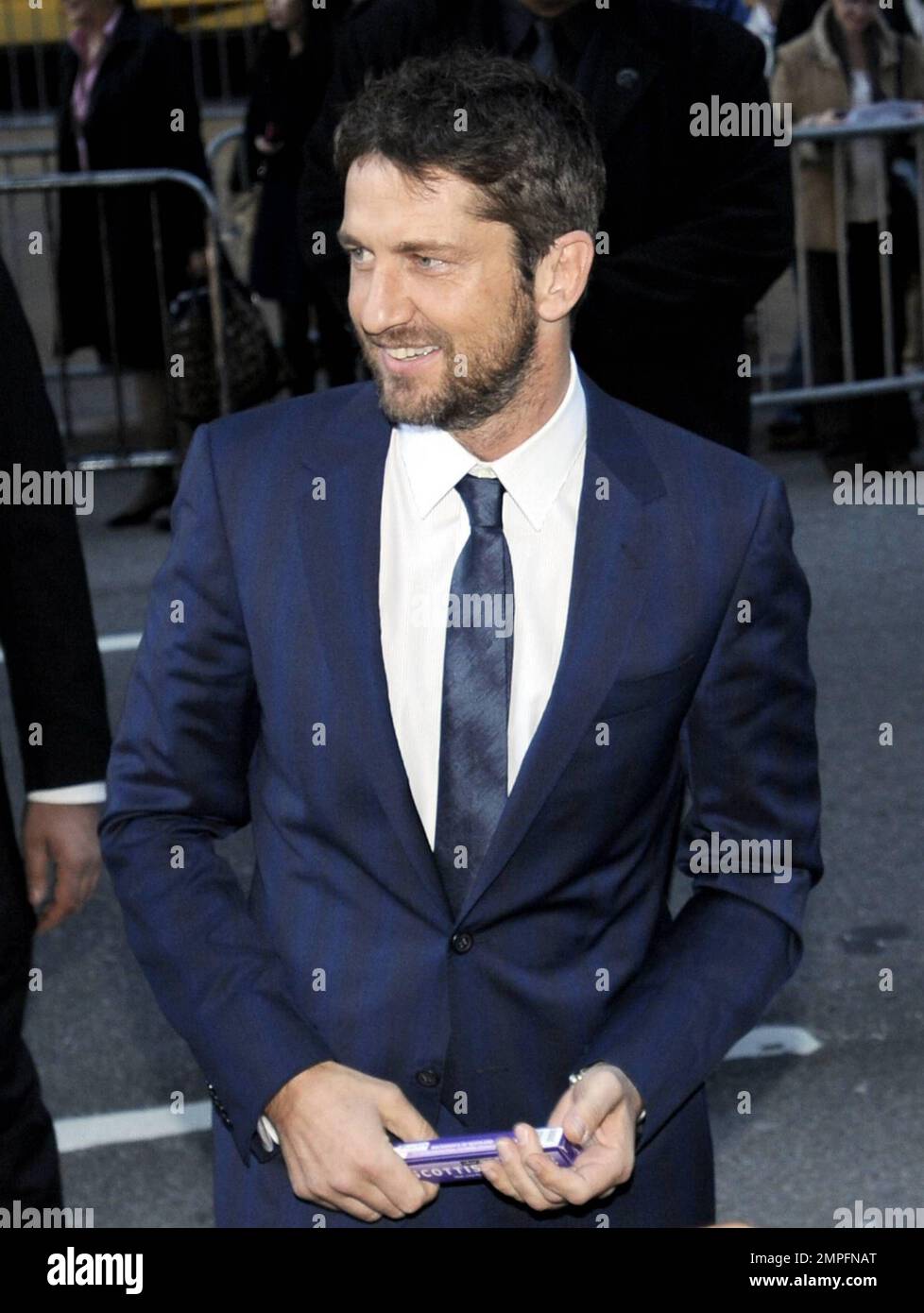 Gerard Butler is all smiles as he greets fans and signs autographs ...