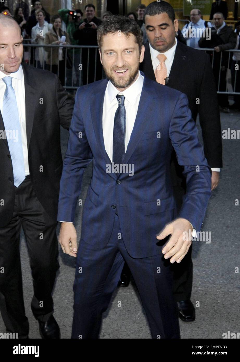 Gerard Butler is all smiles as he greets fans and signs autographs ...