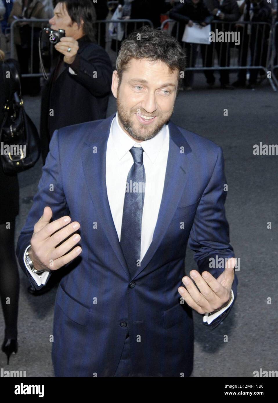 Gerard Butler is all smiles as he greets fans and signs autographs ...