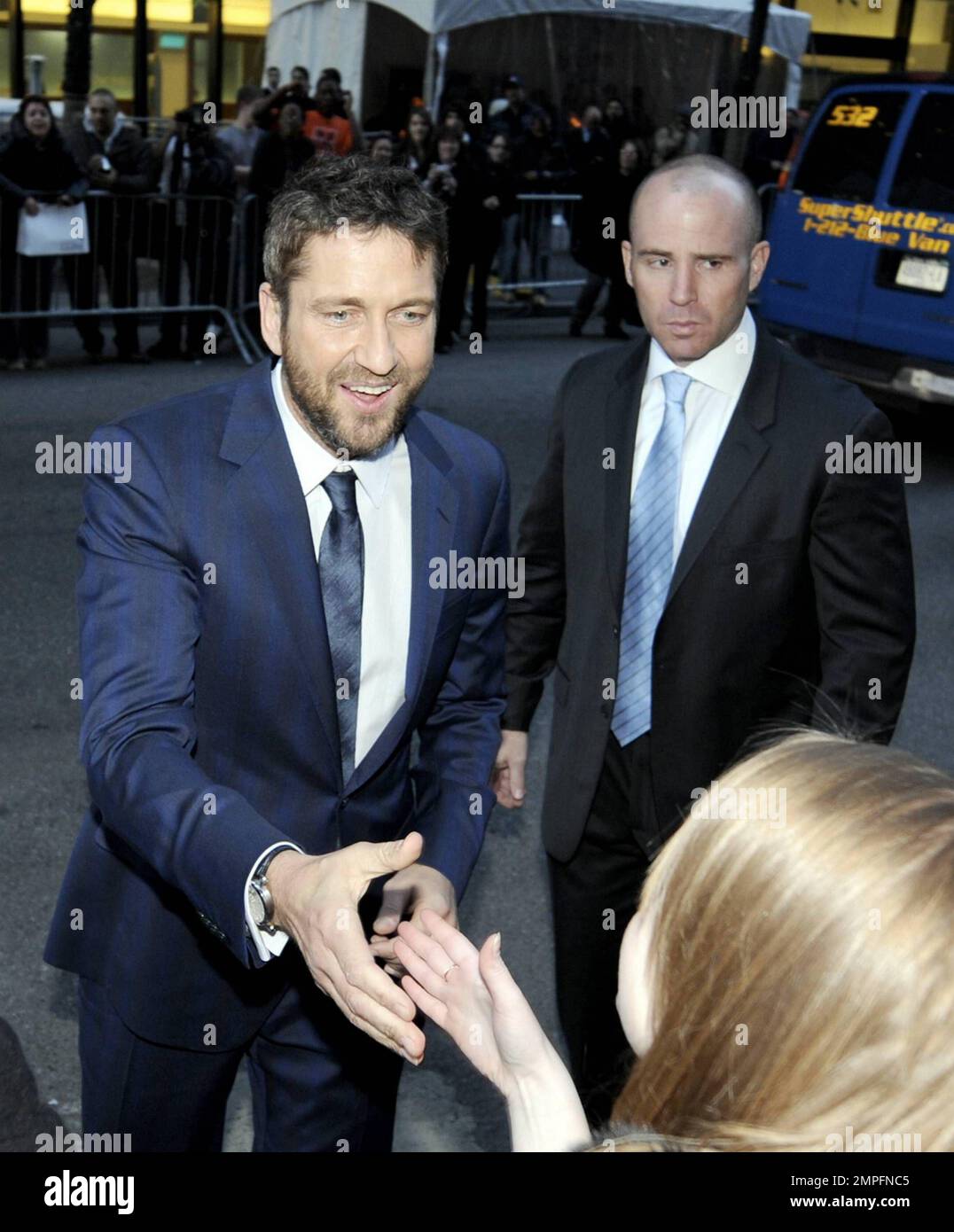 Gerard Butler is all smiles as he greets fans and signs autographs ...