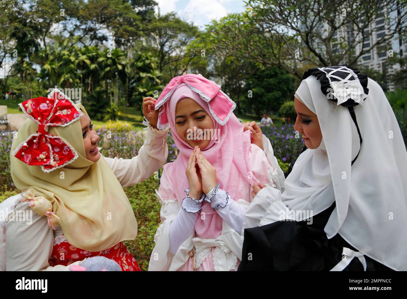 Participants pose during a cosplay event at Kuala Lumpur Convention ...