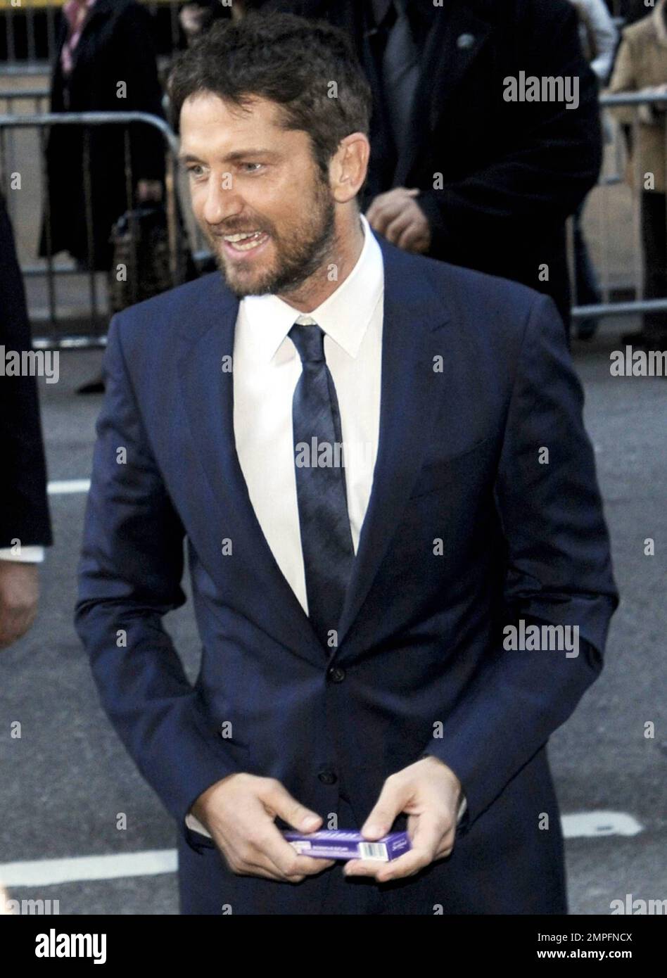 Gerard Butler is all smiles as he greets fans and signs autographs ...