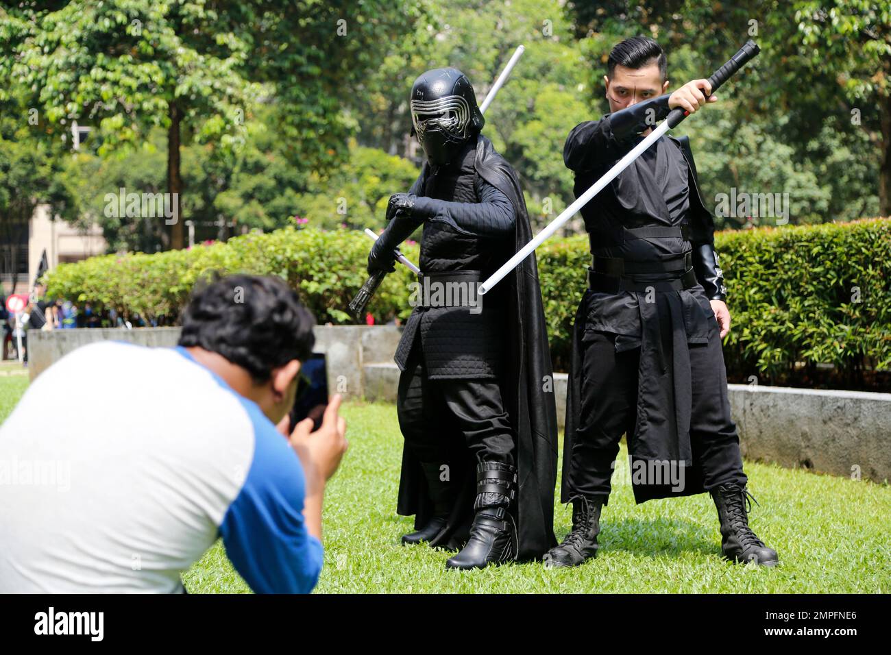 Participants pose during a cosplay event at Kuala Lumpur Convention ...