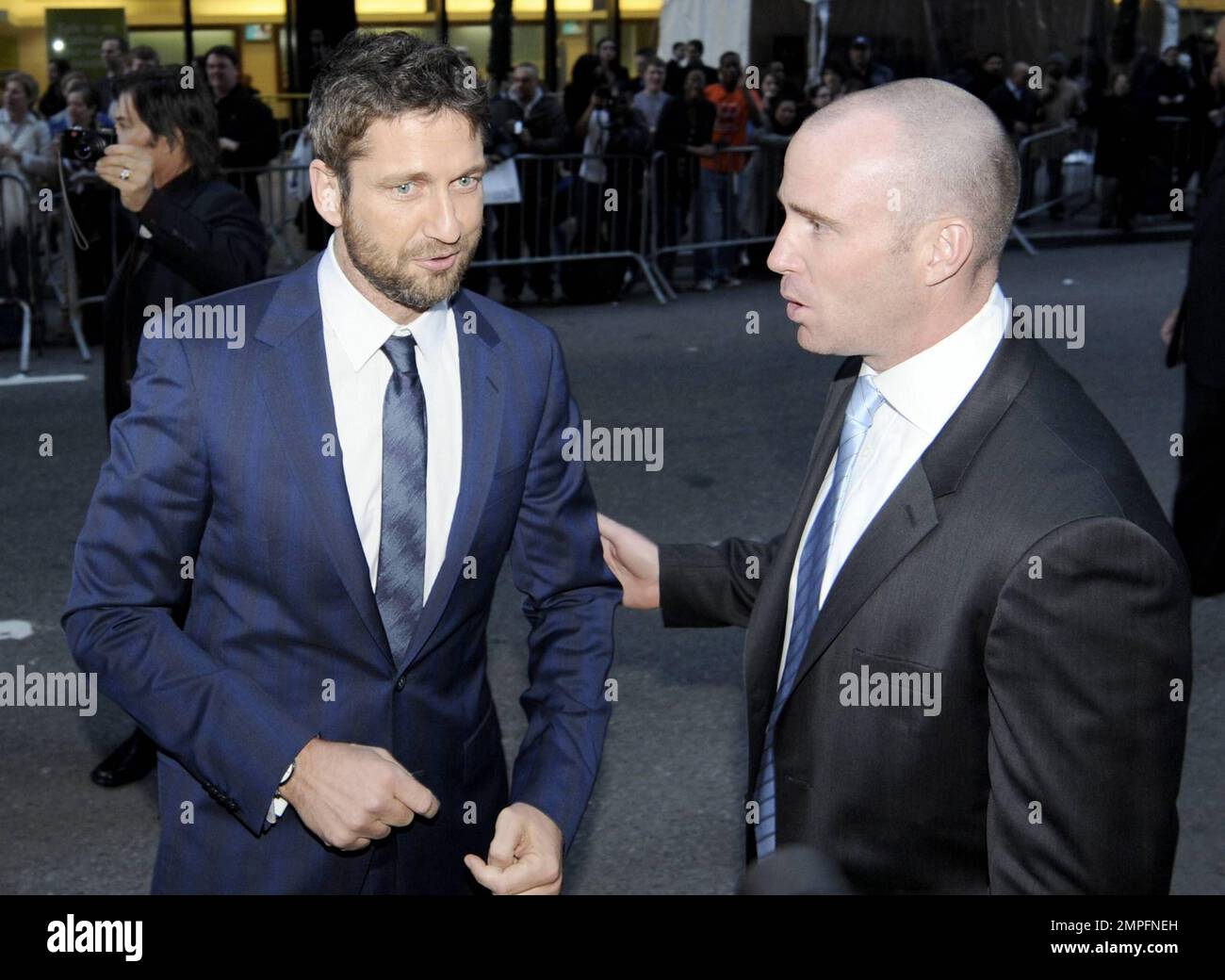 Gerard Butler is all smiles as he greets fans and signs autographs ...
