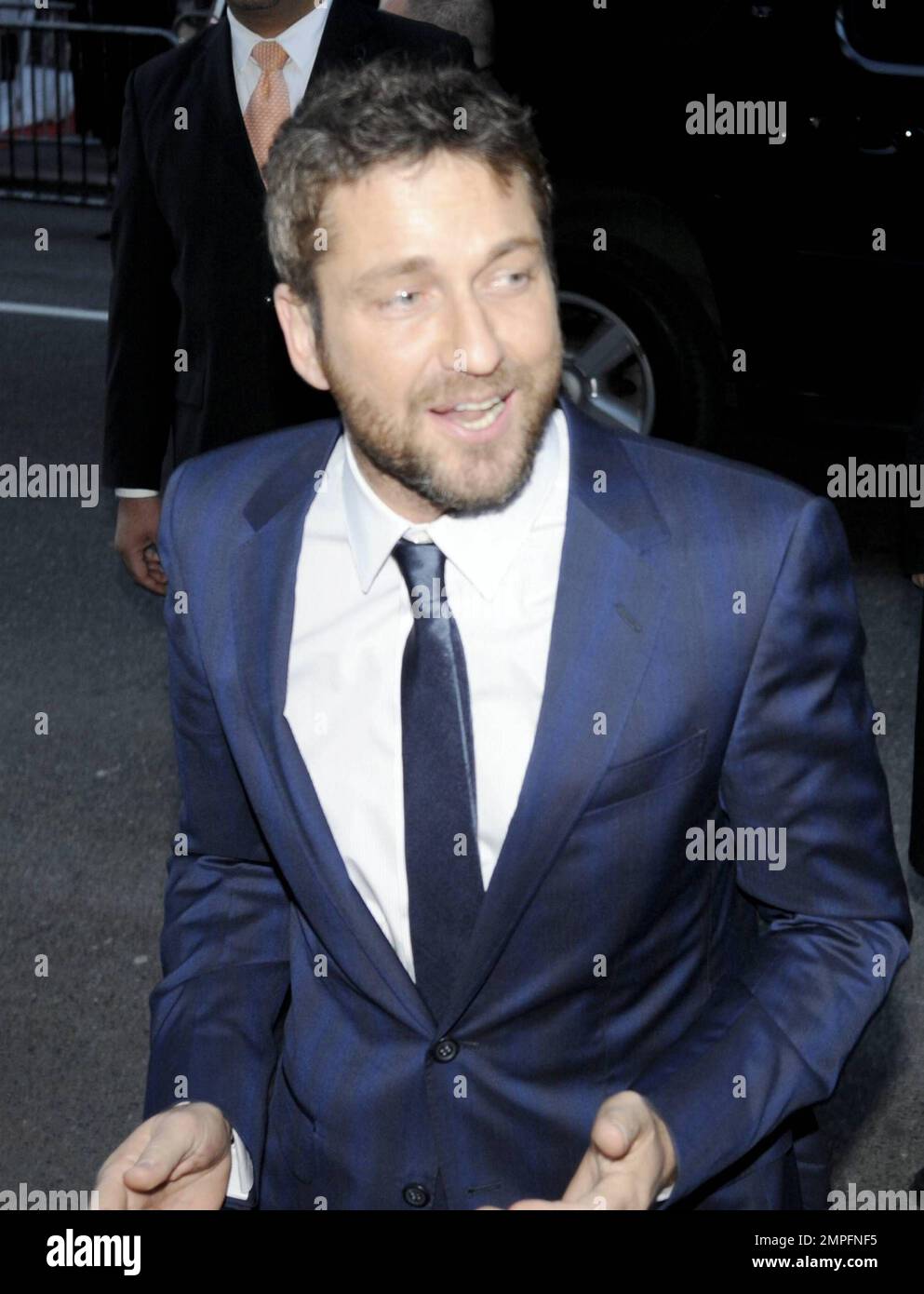 Gerard Butler is all smiles as he greets fans and signs autographs ...