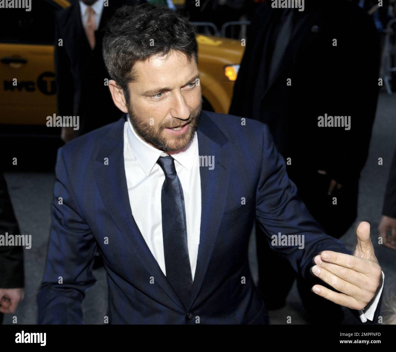 Gerard Butler is all smiles as he greets fans and signs autographs ...