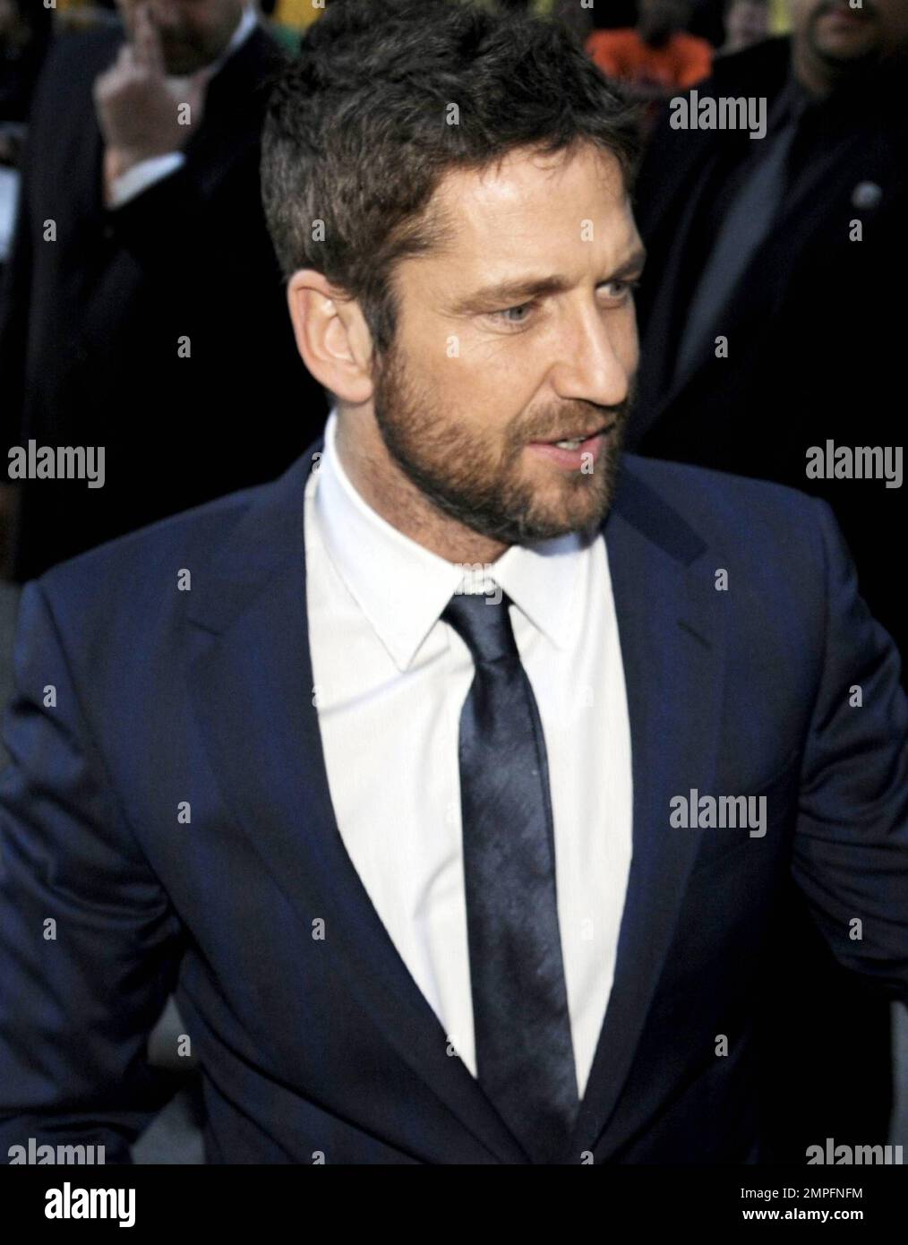 Gerard Butler is all smiles as he greets fans and signs autographs ...