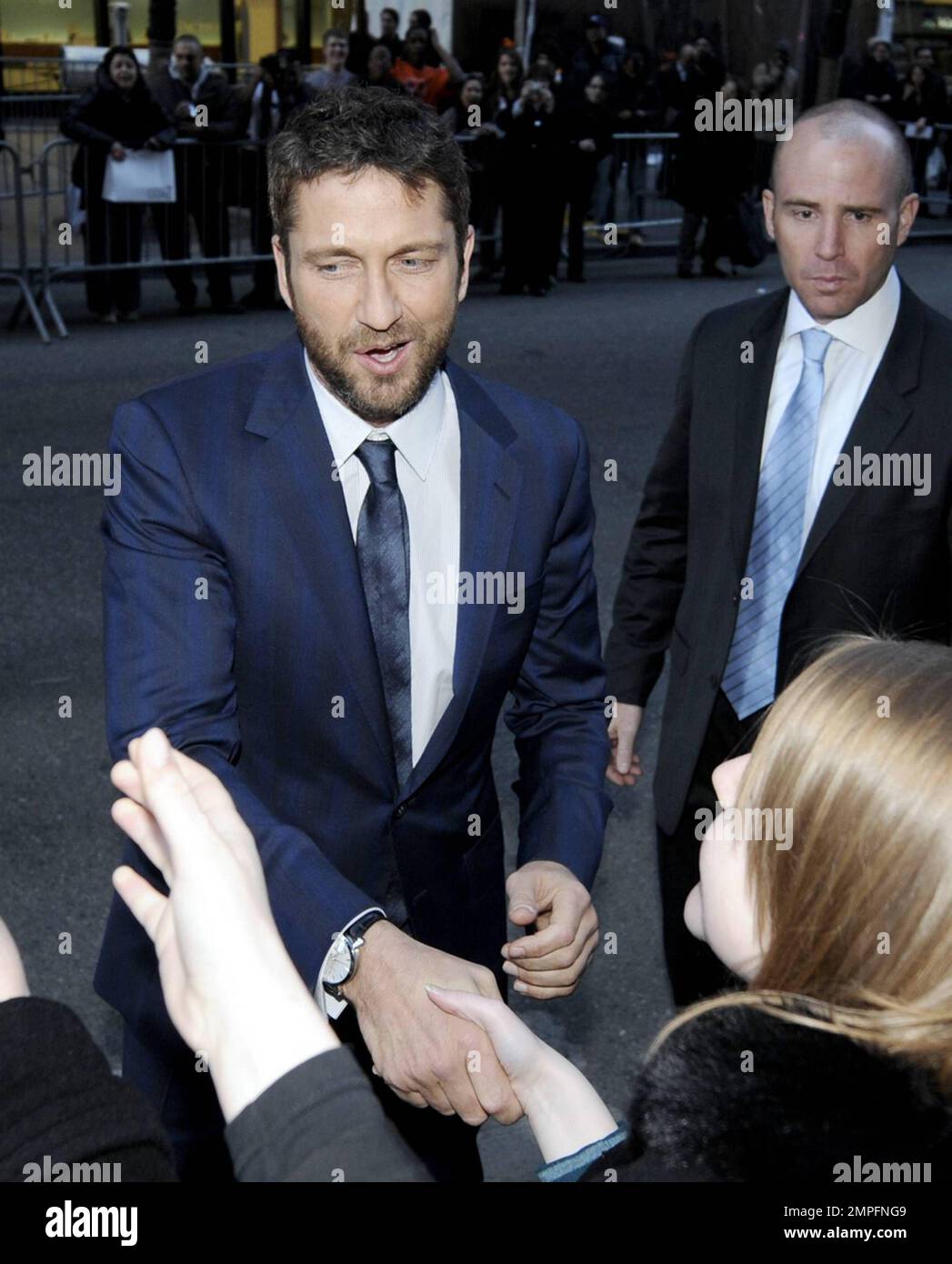 Gerard Butler is all smiles as he greets fans and signs autographs ...