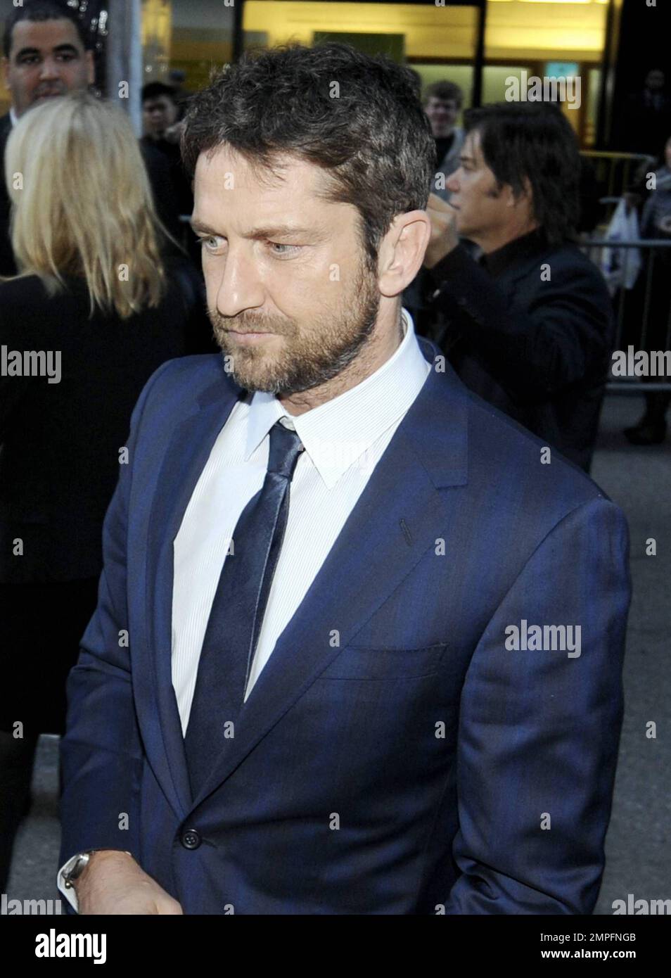 Gerard Butler is all smiles as he greets fans and signs autographs ...