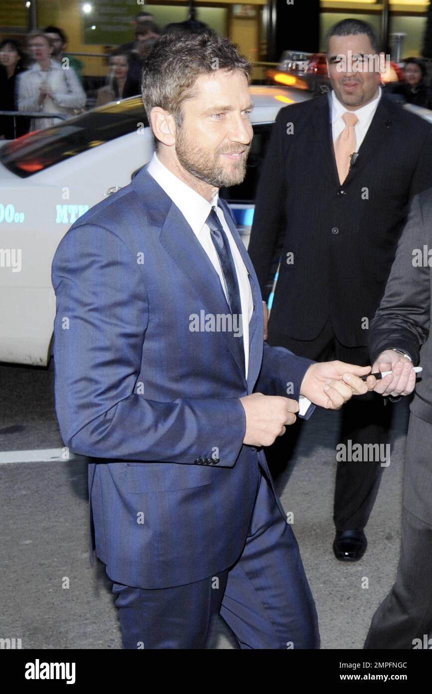 Gerard Butler is all smiles as he greets fans and signs autographs ...