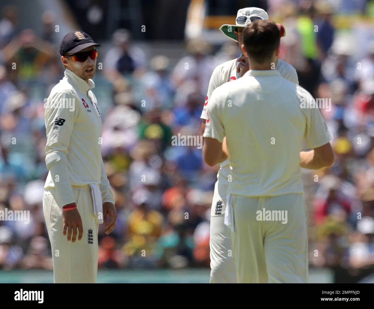 England captain Joe Root, left, talks with his bowlers Stuart Broad and ...