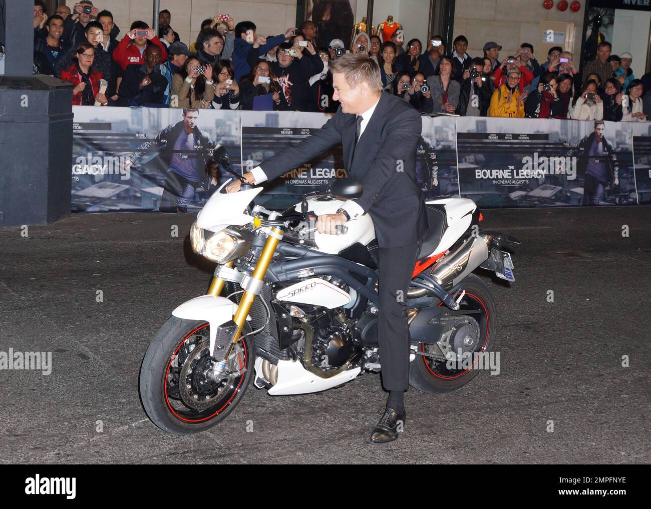Jeremy Renner arrives on a motorcycle at the premiere of "The Bourne ...