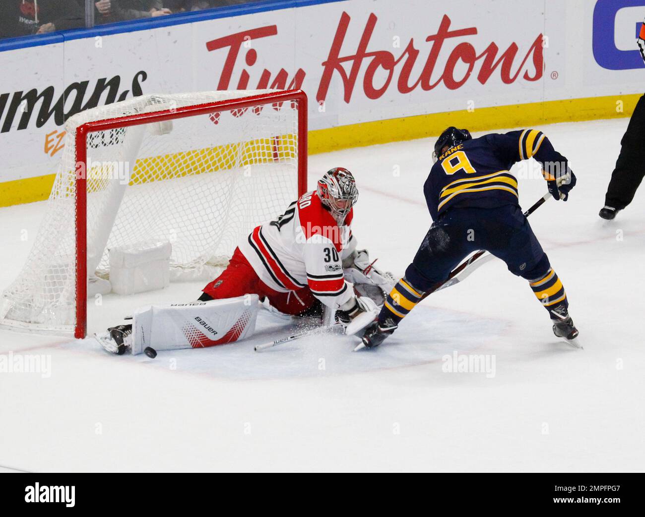 Buffalo Sabres forward Evander Kane (9) is stopped by Carolina ...