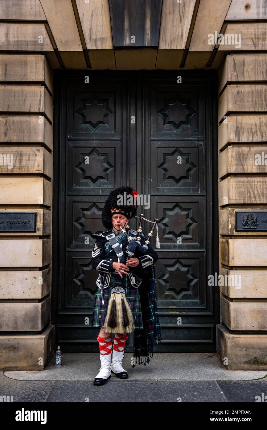 A Scottish bagpiper in traditional clothing and Scottish kilt on the ...