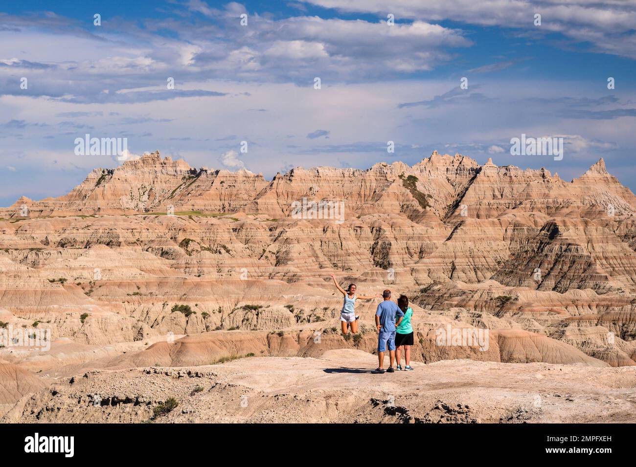 Family taking photos of daughter jumping at White River Valley Overlook ...