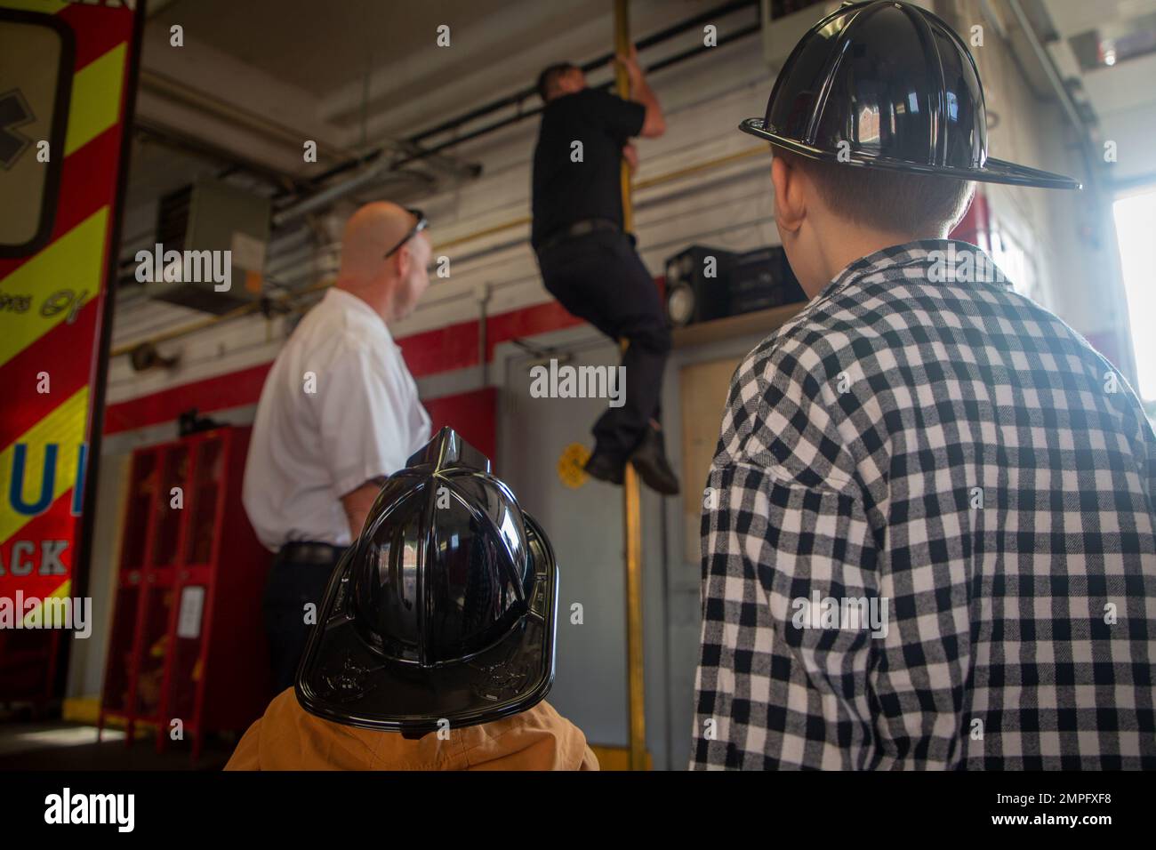 Children watch a demonstration of how firefighters use the fireman’s ...