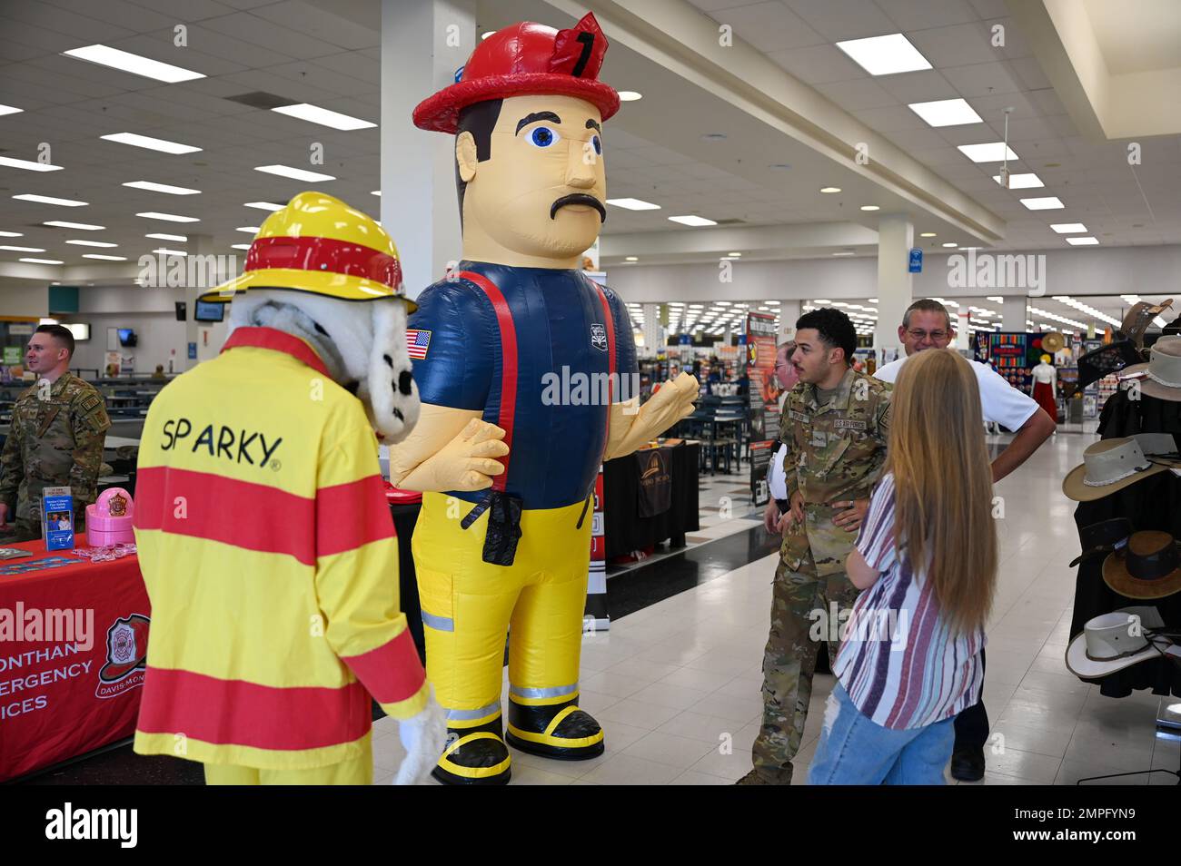 Fire mascots talk with people about fire safety practices in the Base ...