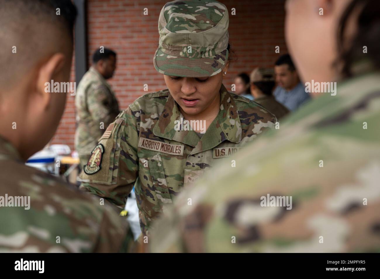 Airman 1st Class Yaimelie Arroyo Morales, 4th Force Support Squadron personnelist, gives out ...