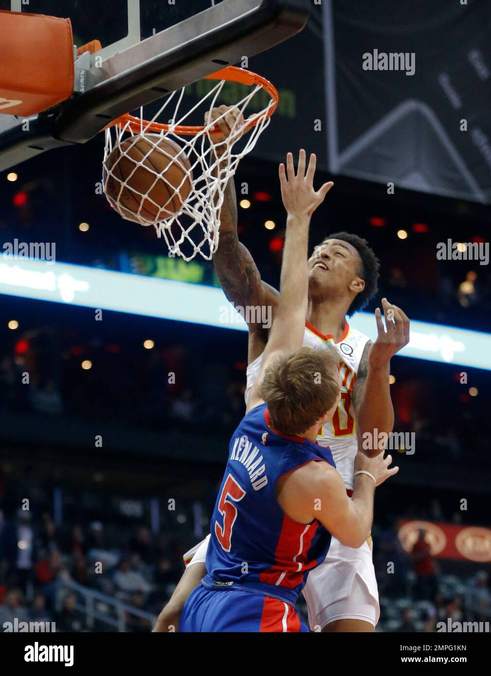 Atlanta Hawks forward John Collins (20) scores as Detroit Pistons guard ...