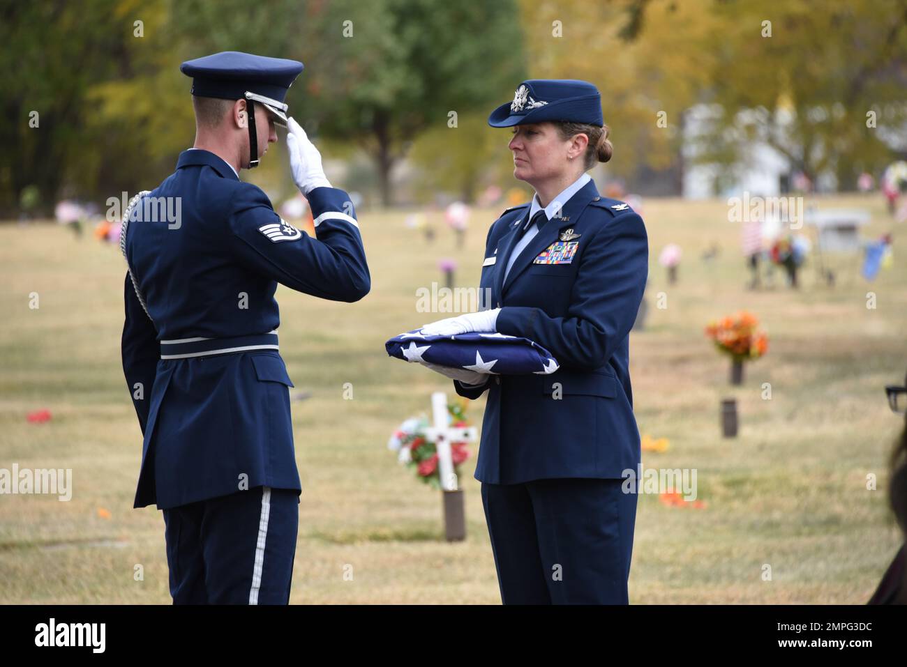 A 185th Air Refueling Wing Honor Guard member presents a U.S. flag to ...