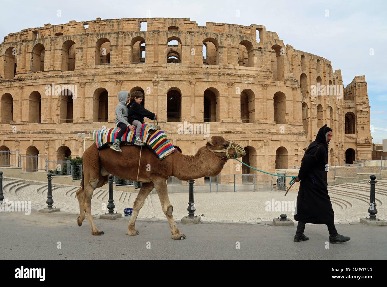 Children riding a camel at the Amphitheatre of El Jem in Tunisia Stock ...