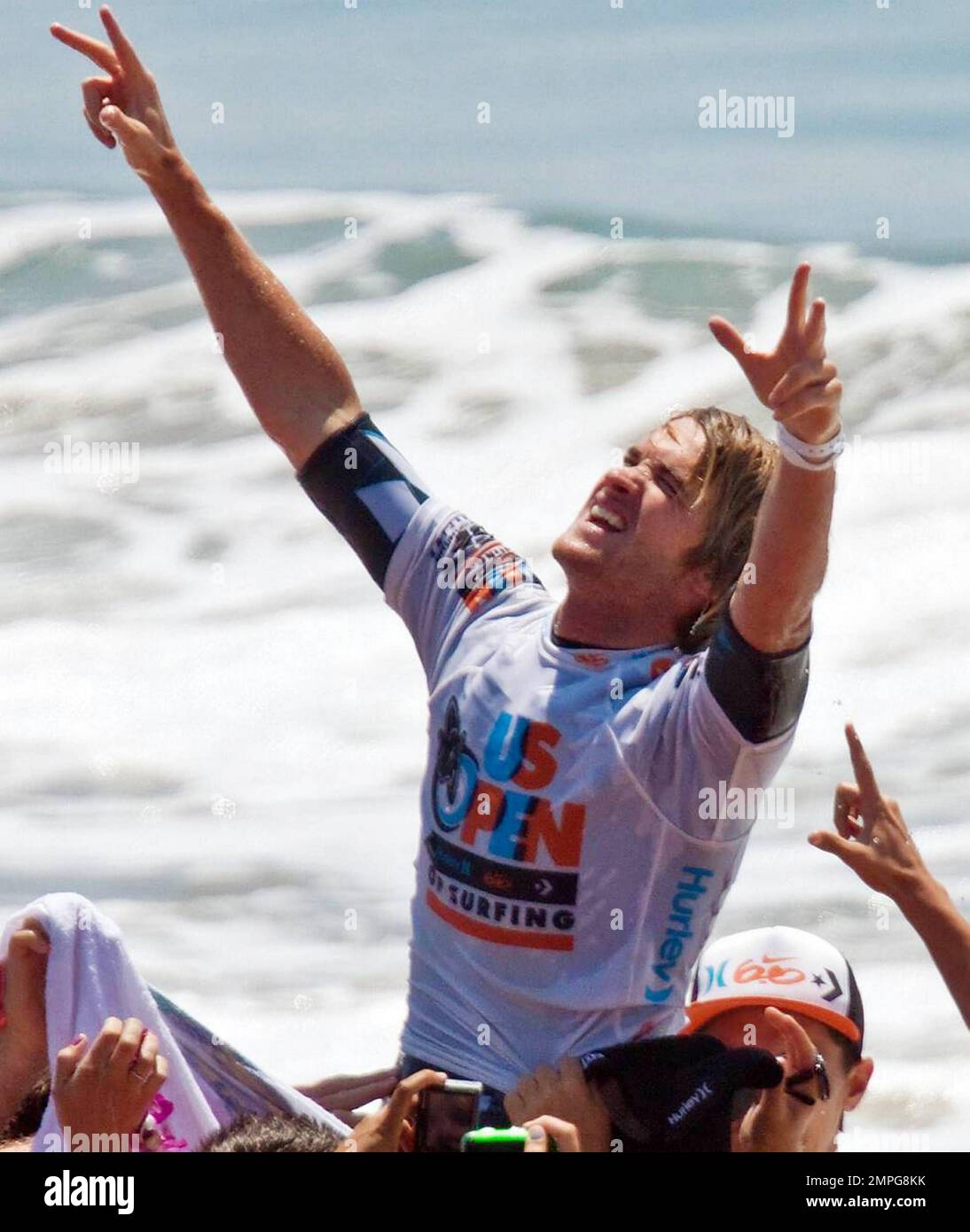 Huntington Beach native Brett Simpson flashes the peace sign as he is ...