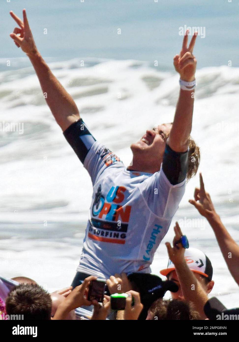Huntington Beach native Brett Simpson flashes the peace sign as he is ...