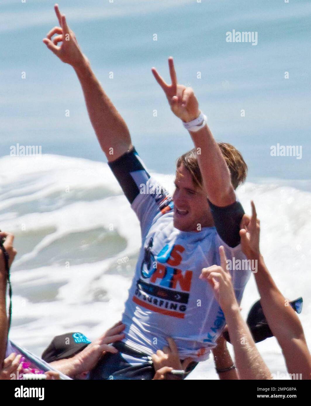 Huntington Beach native Brett Simpson flashes the peace sign as he is ...