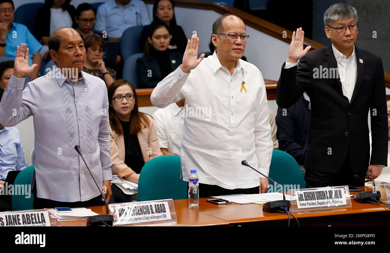 Former Philippine President Benigno Aquino III, center, takes his oath ...