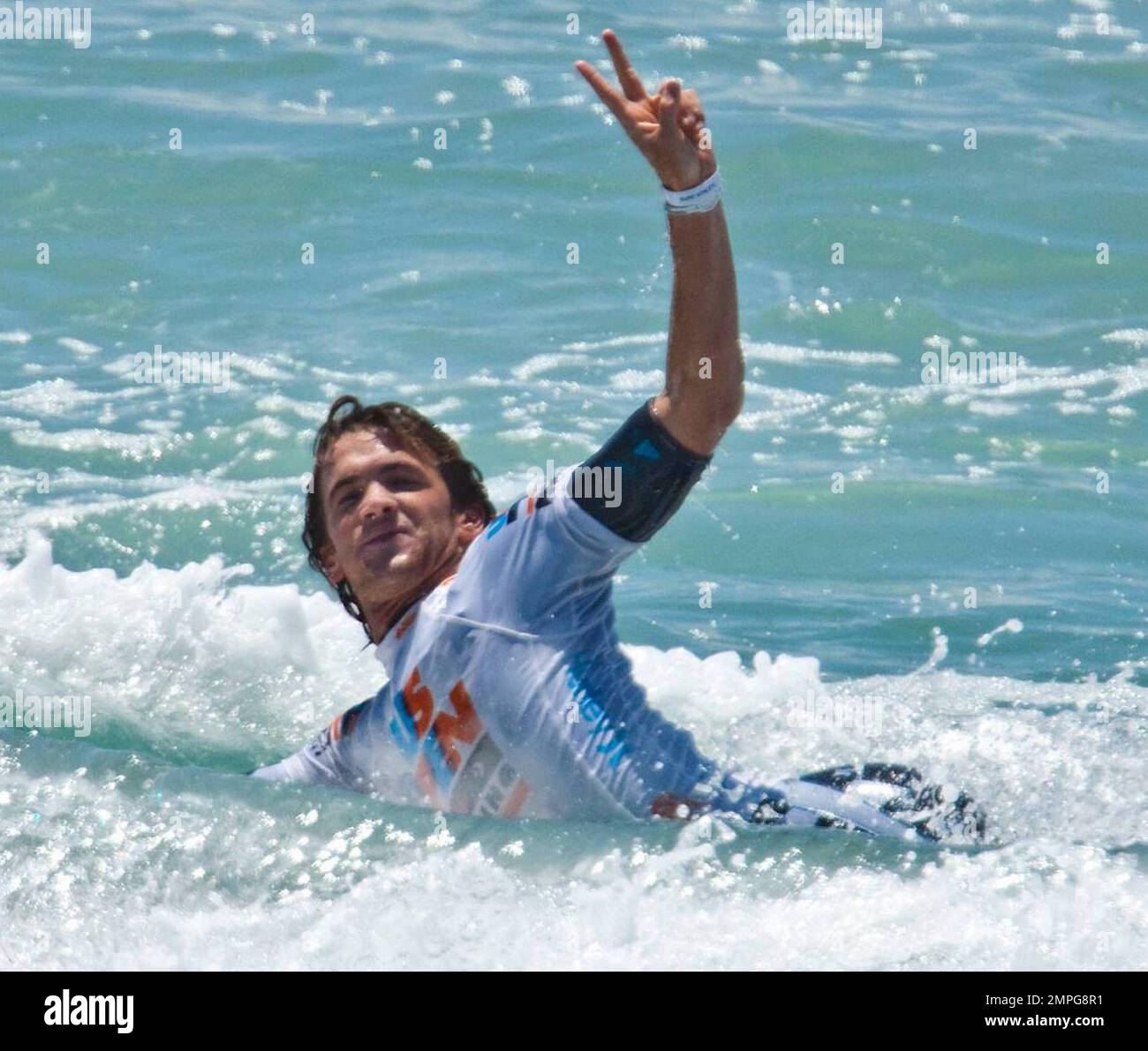 Huntington Beach native Brett Simpson flashes the peace sign as he is ...