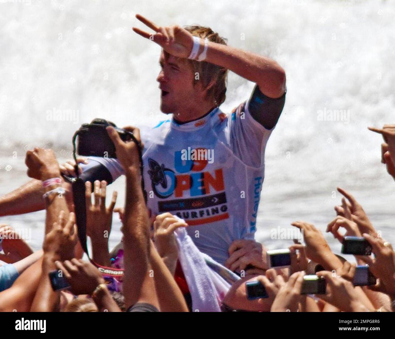 Huntington Beach native Brett Simpson flashes the peace sign as he is ...
