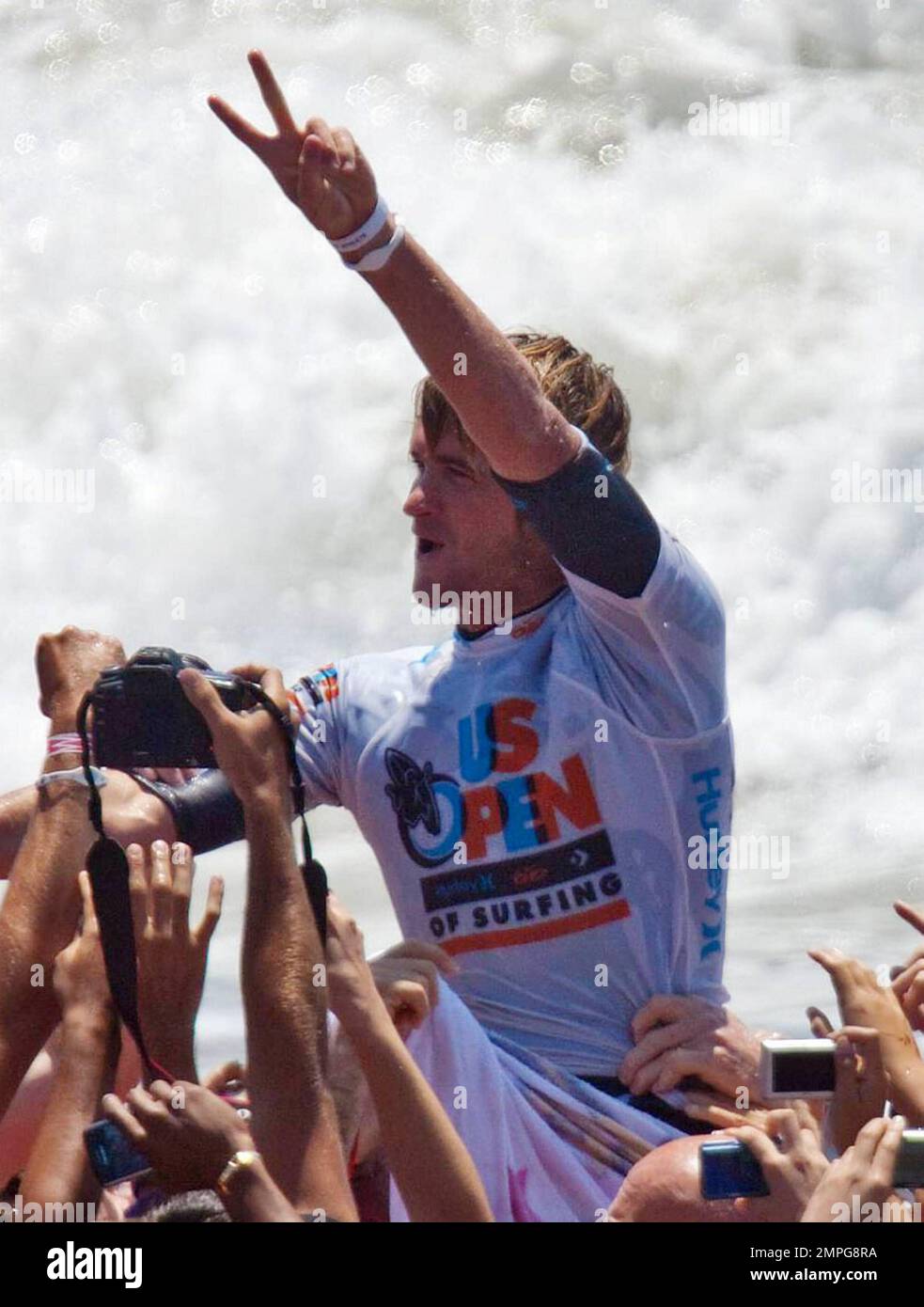 Huntington Beach native Brett Simpson flashes the peace sign as he is ...
