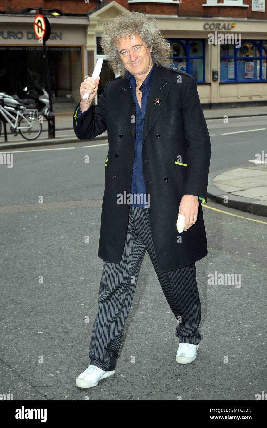 Queen guitarist Brian May sports a large bandage on one of his fingers ...