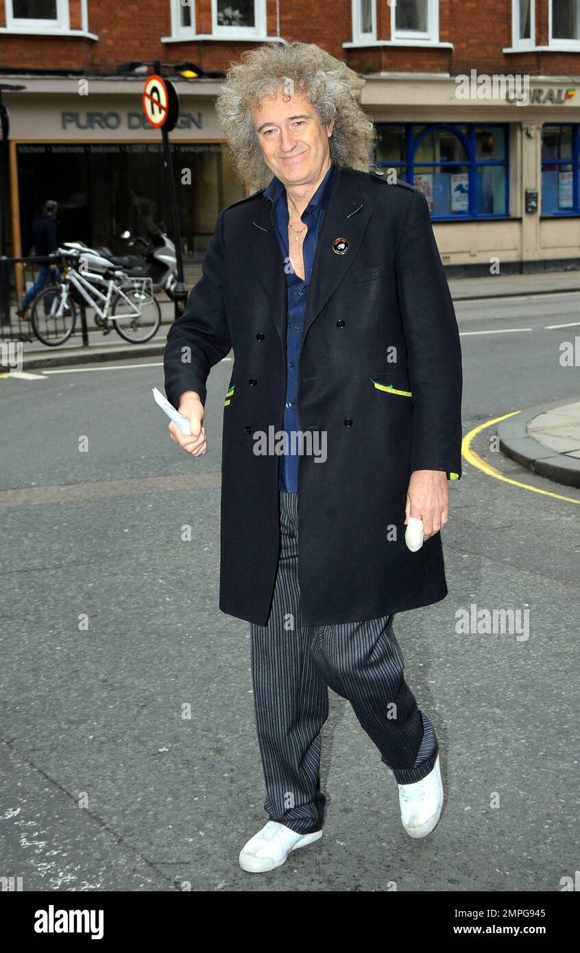 Queen guitarist Brian May sports a large bandage on one of his fingers ...