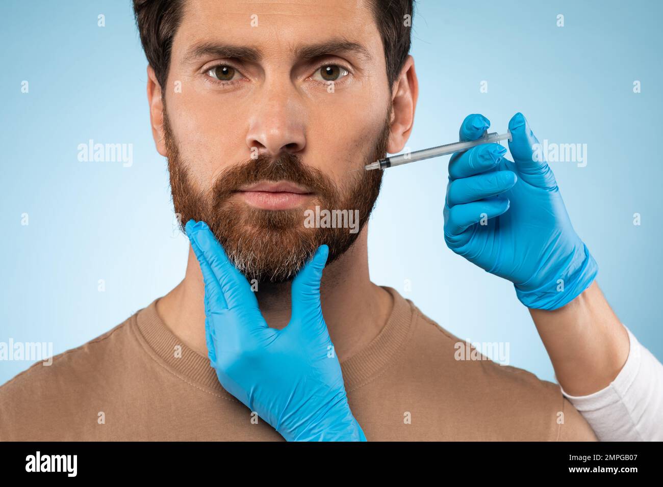 Male injective cosmetology concept. Handsome bearded middle aged man ...