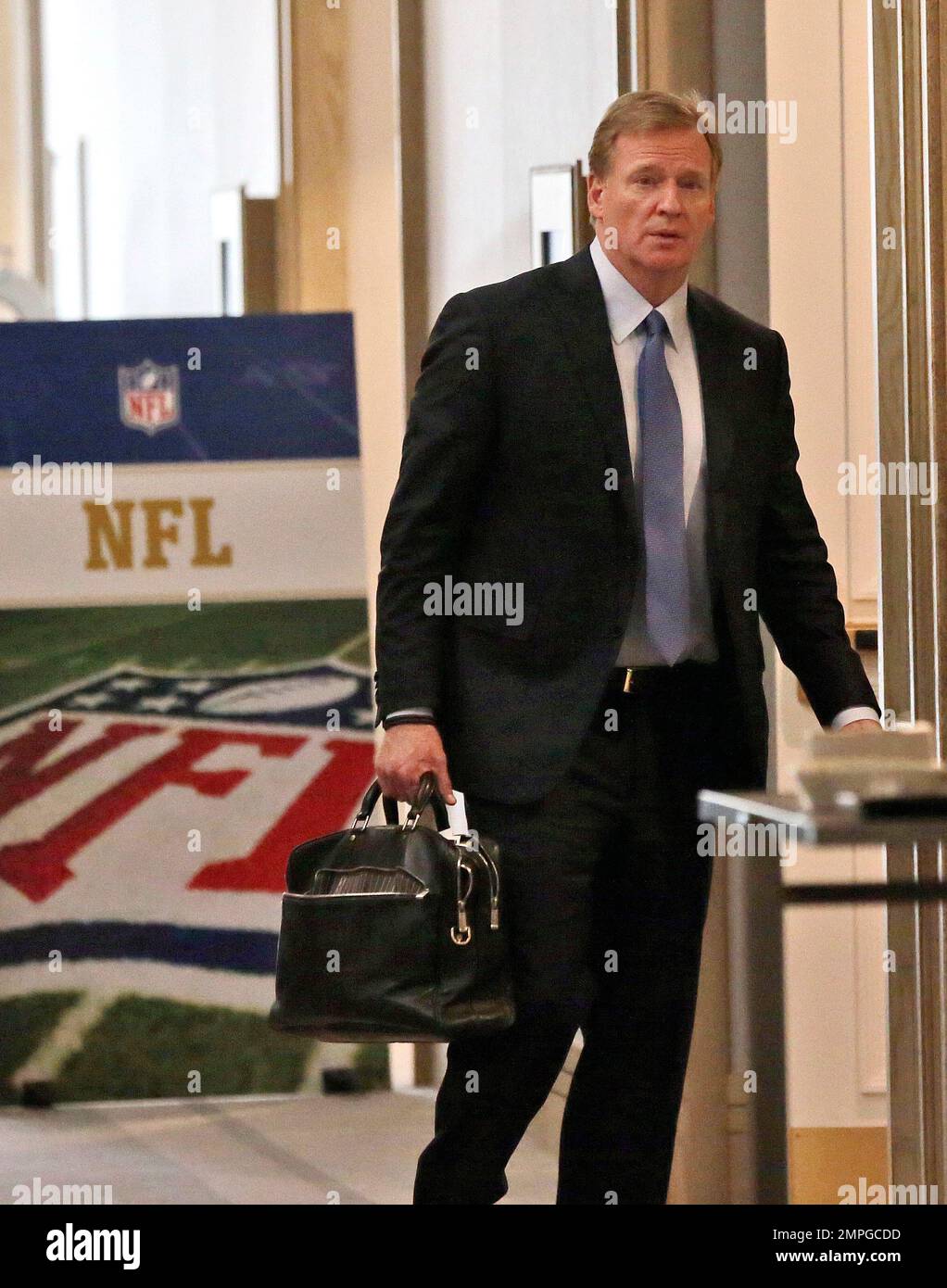 NFL Commissioner Roger Goodell walks in a hallway during a break at the ...