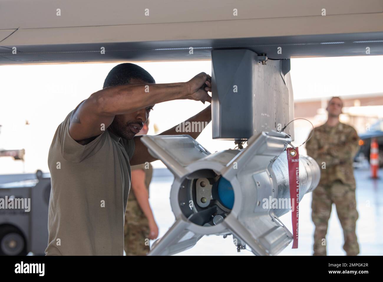 U.S. Air Force Senior Airman Deangelo, left, 432nd Aircraft Maintenance Squadron load crew chief ...