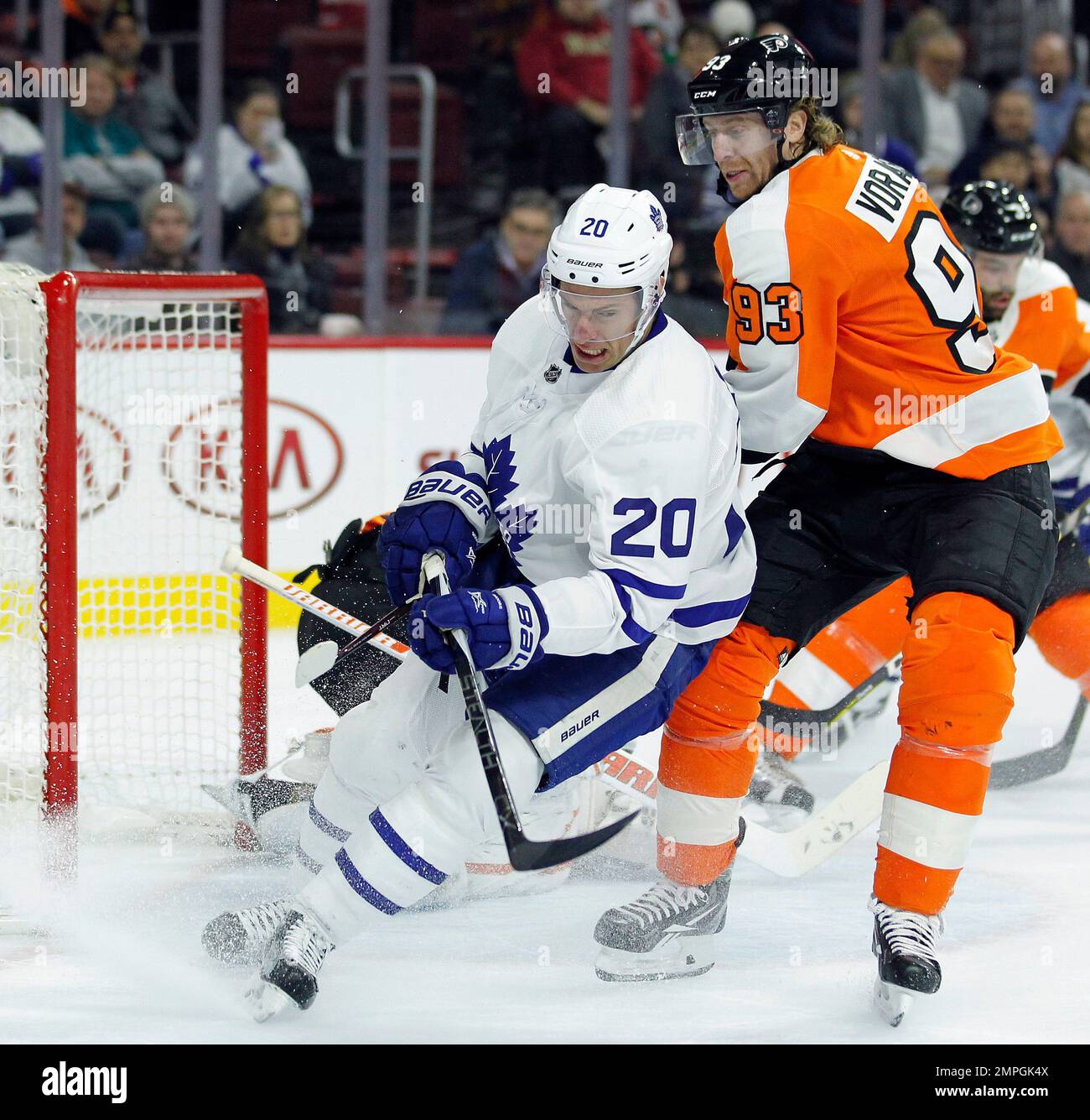 Toronto Maple Leafs' Dominic Moore, left, followed by Philadelphia ...