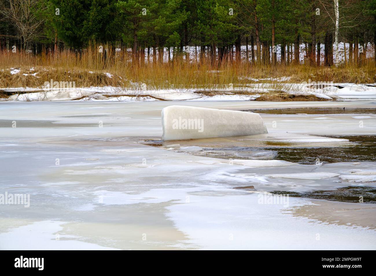 Spring is coming in Latvia. The ice is breaking on the river. A piece ...