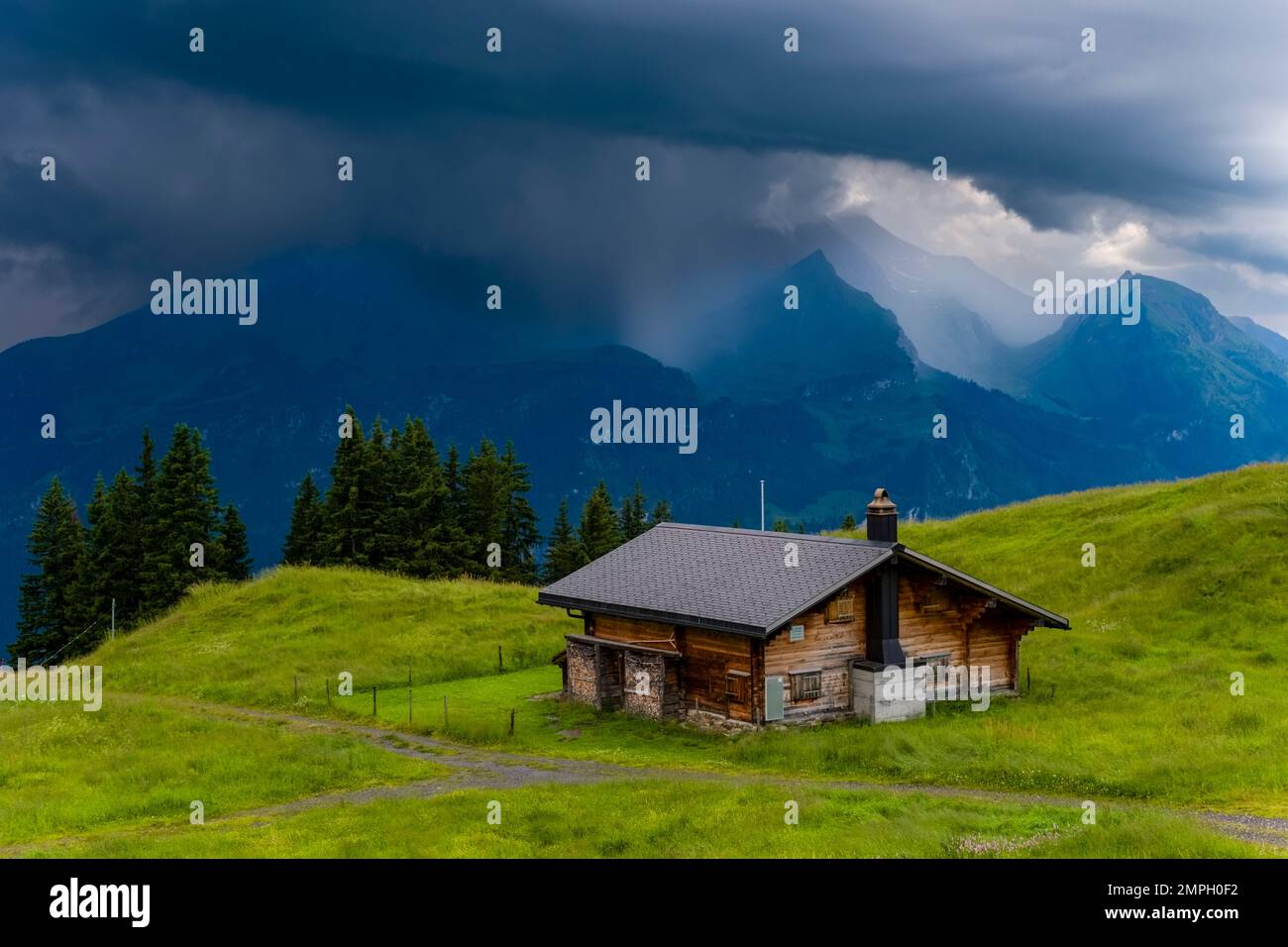 A farmhouse in an agricultural landscape, the opposite mountains of the ...